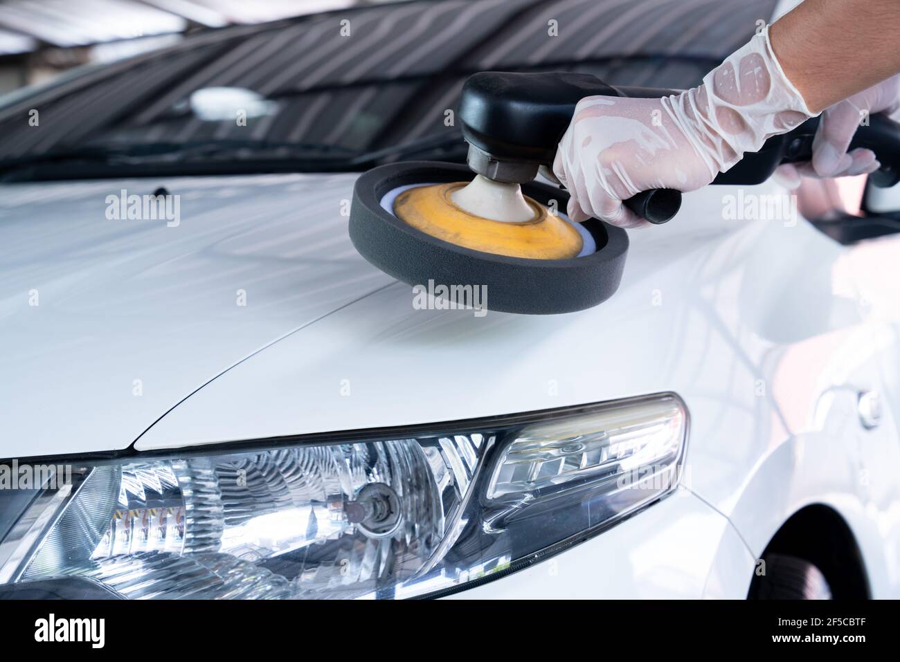 hand of car wash white car is polishing in the garage, Car wash service ...