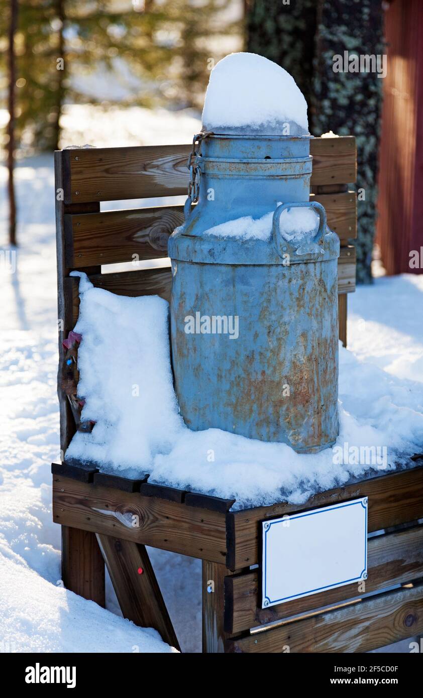 an old milk bucket that has been snowed over Stock Photo - Alamy