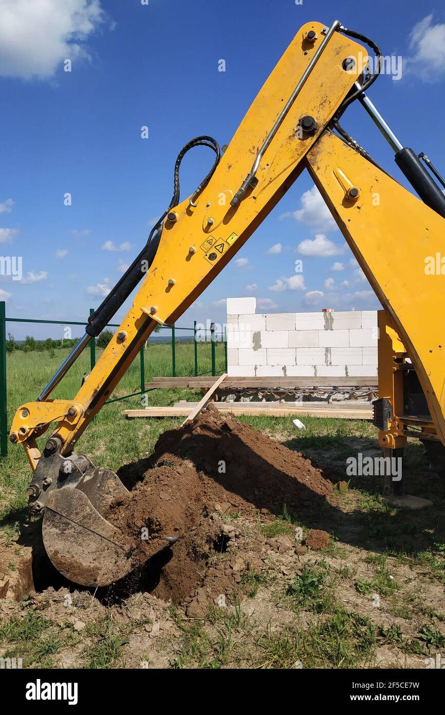 excavator on a construction site digs ditches, the process of work ...