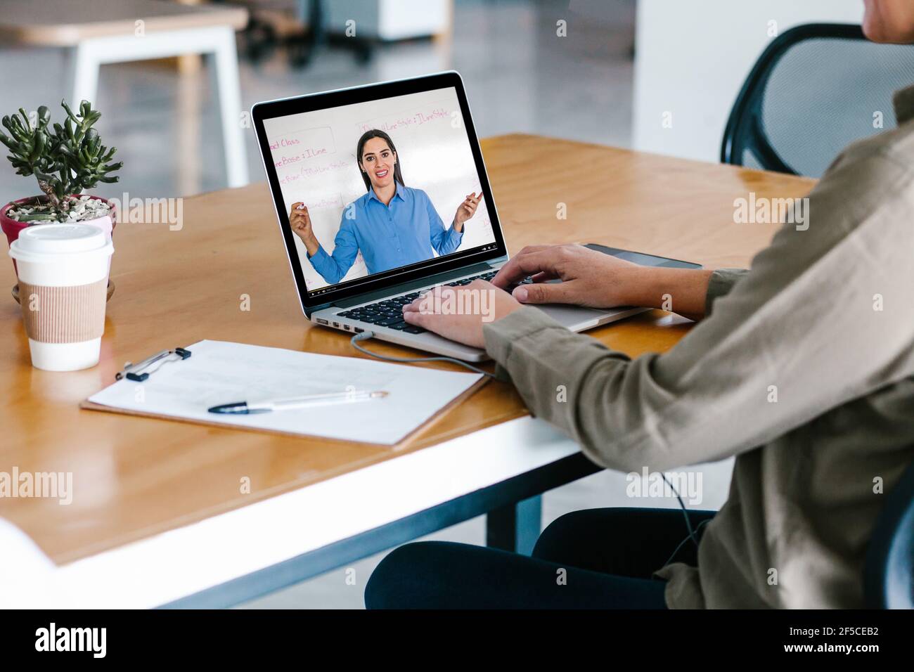 latin woman student watching lesson online and studying from home in ...