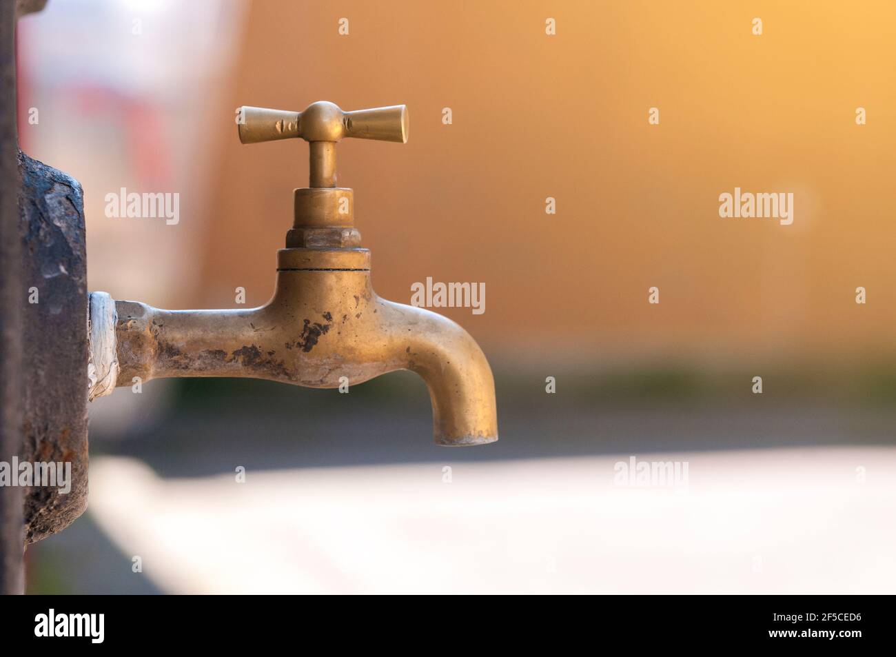 Old italian metal water tap on blurred orange background Stock Photo ...