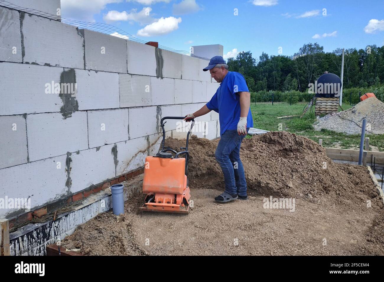 Construction work on the construction site, soil compaction with a ...