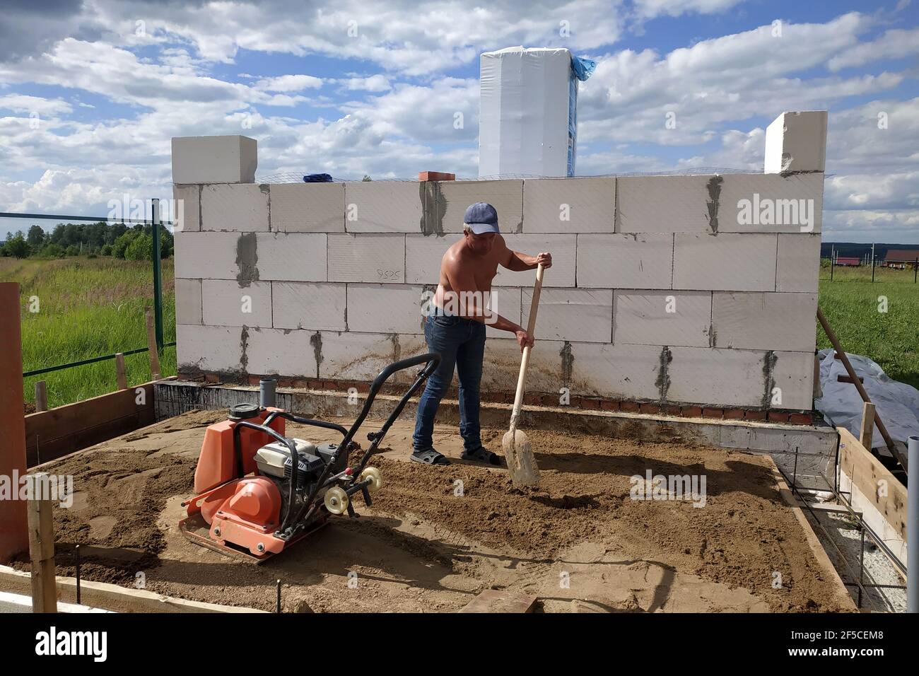 Vibrating plate in use, the worker with the help of a vibrating plate ...