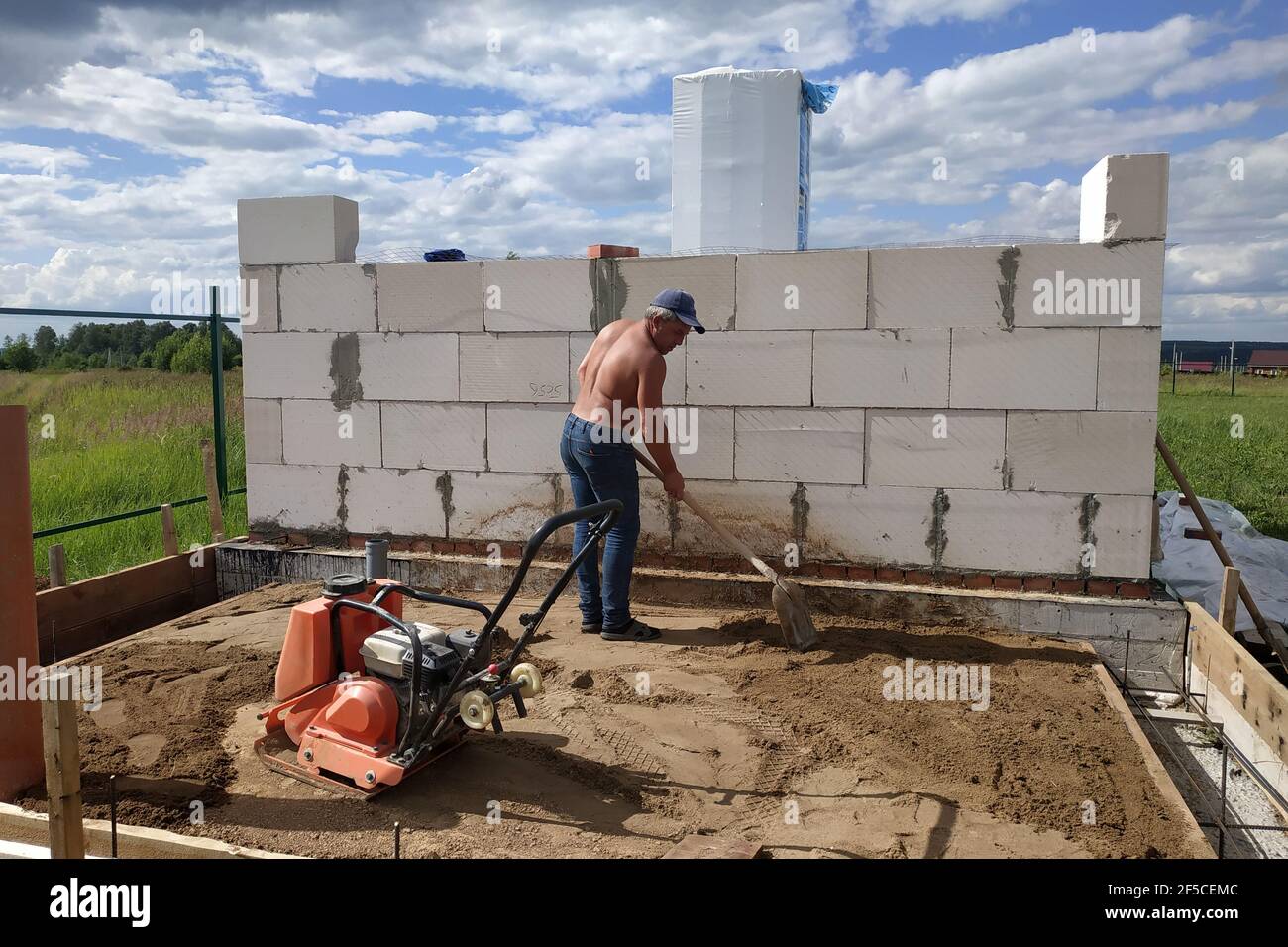 Vibrating plate in use, the worker with the help of a vibrating plate ...