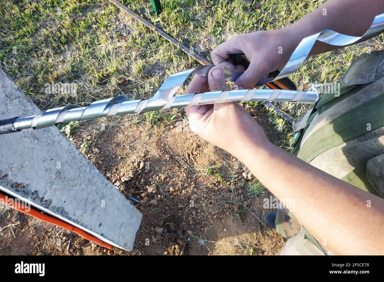 Wiring of an electric cable on the dug trench, supply of the electric ...