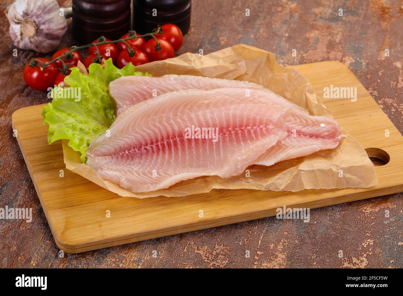 Raw tilapia fish ready for cooking Stock Photo - Alamy
