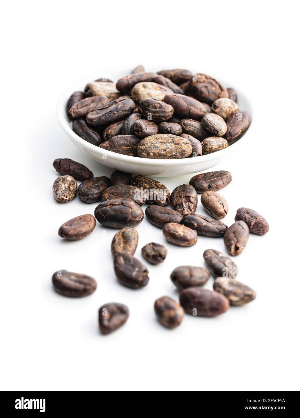 Roasted cocoa beans in bowl isolated on white background Stock Photo ...