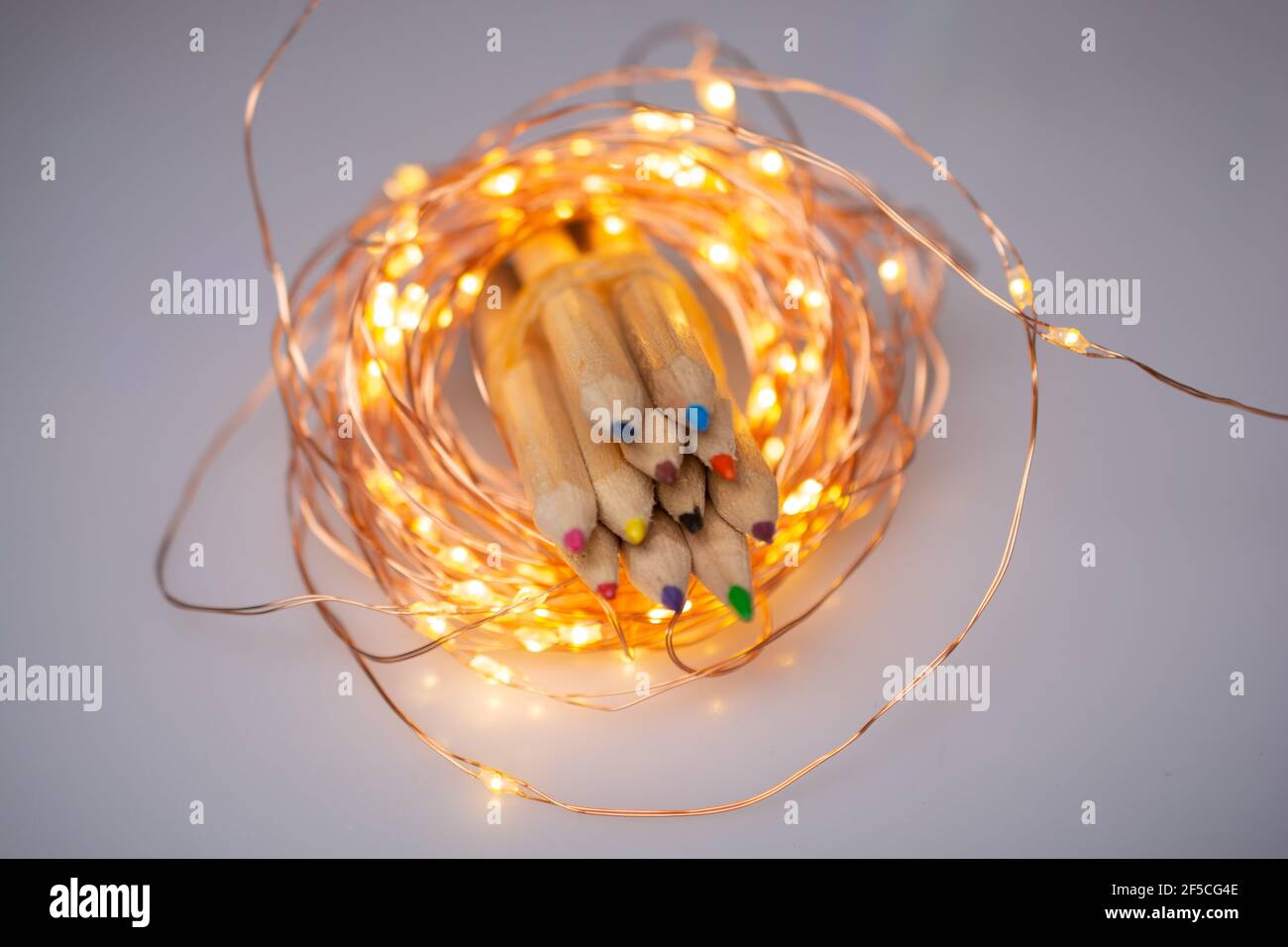 Many colored pencilswith fairy lights. Children's colored pencils for ...