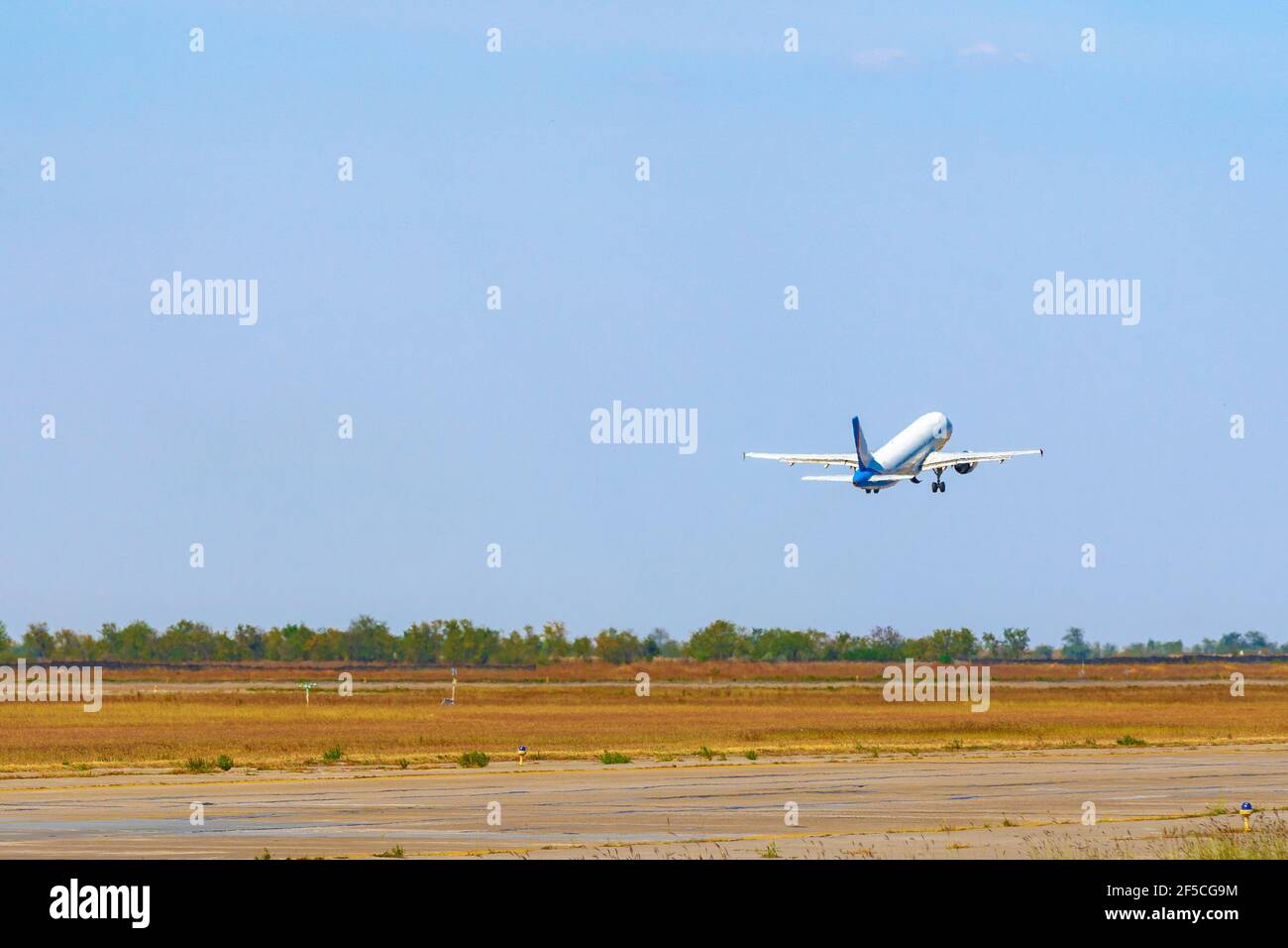 Passenger plane takes off from runway in airport Stock Photo - Alamy