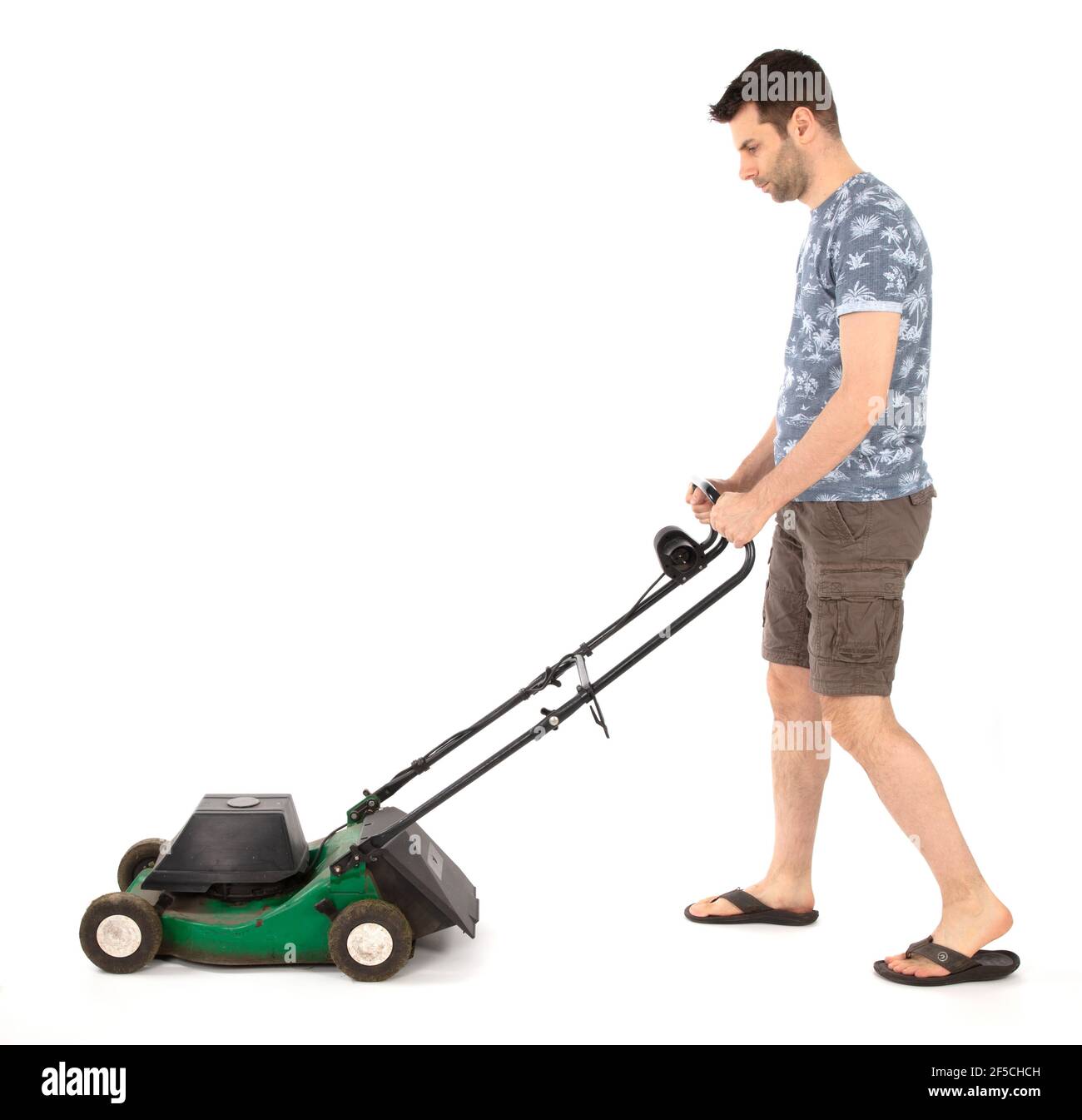 Man pushing old green lawn mower - Isolated on white background Stock ...