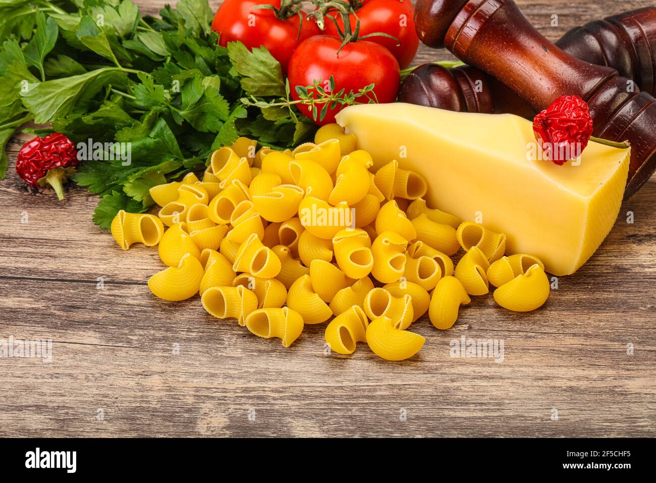 Italian pasta - raw pipe rigate served vegetables Stock Photo - Alamy