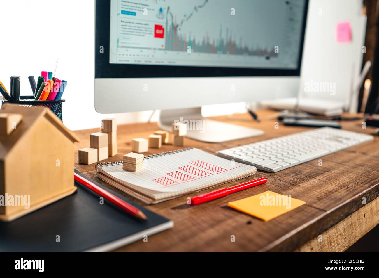 Drawing a graph of growth in a notebook on your desk at home.Wooden ...