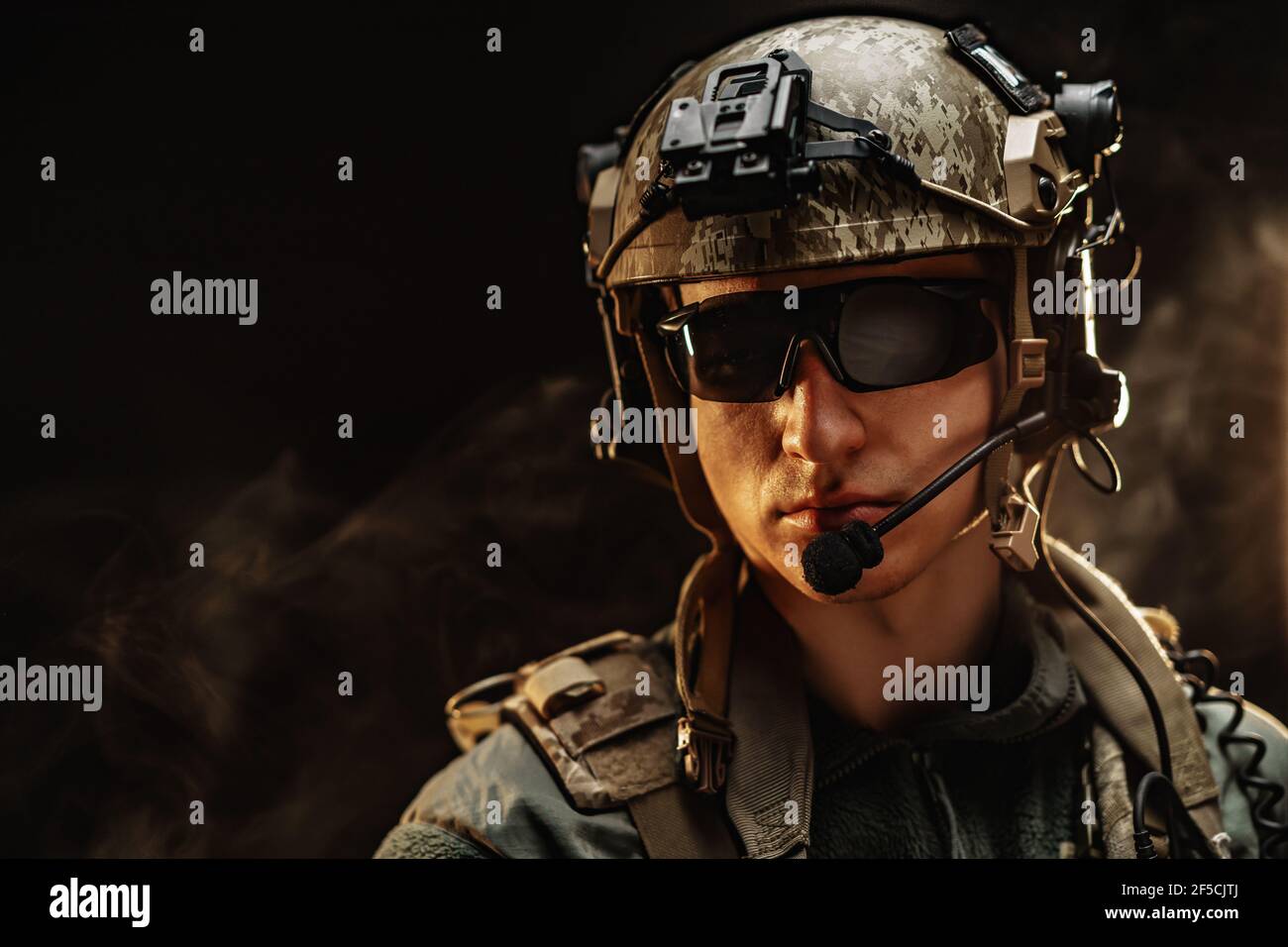 Portrait of special forces soldier in helmet and glasses in the dark ...