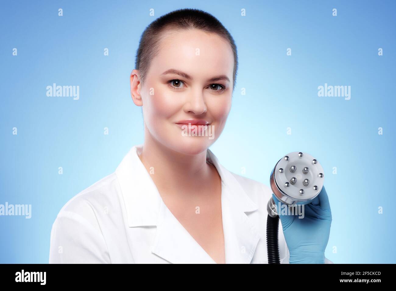 Portrait of a woman dermatologist holding cosmetic device attachment ...