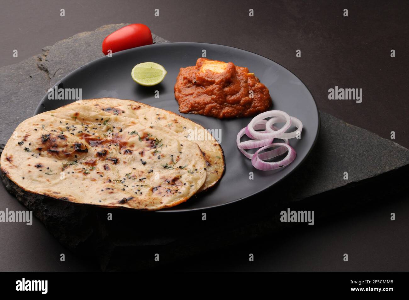 Paneer Butter Masala or Cheese Cottage Curry served with naan or ...