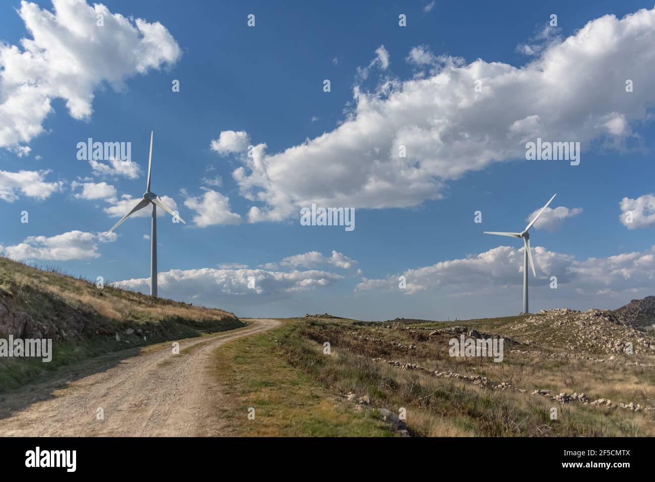 View of a top mountains landscape with a wind turbines, green herb ...