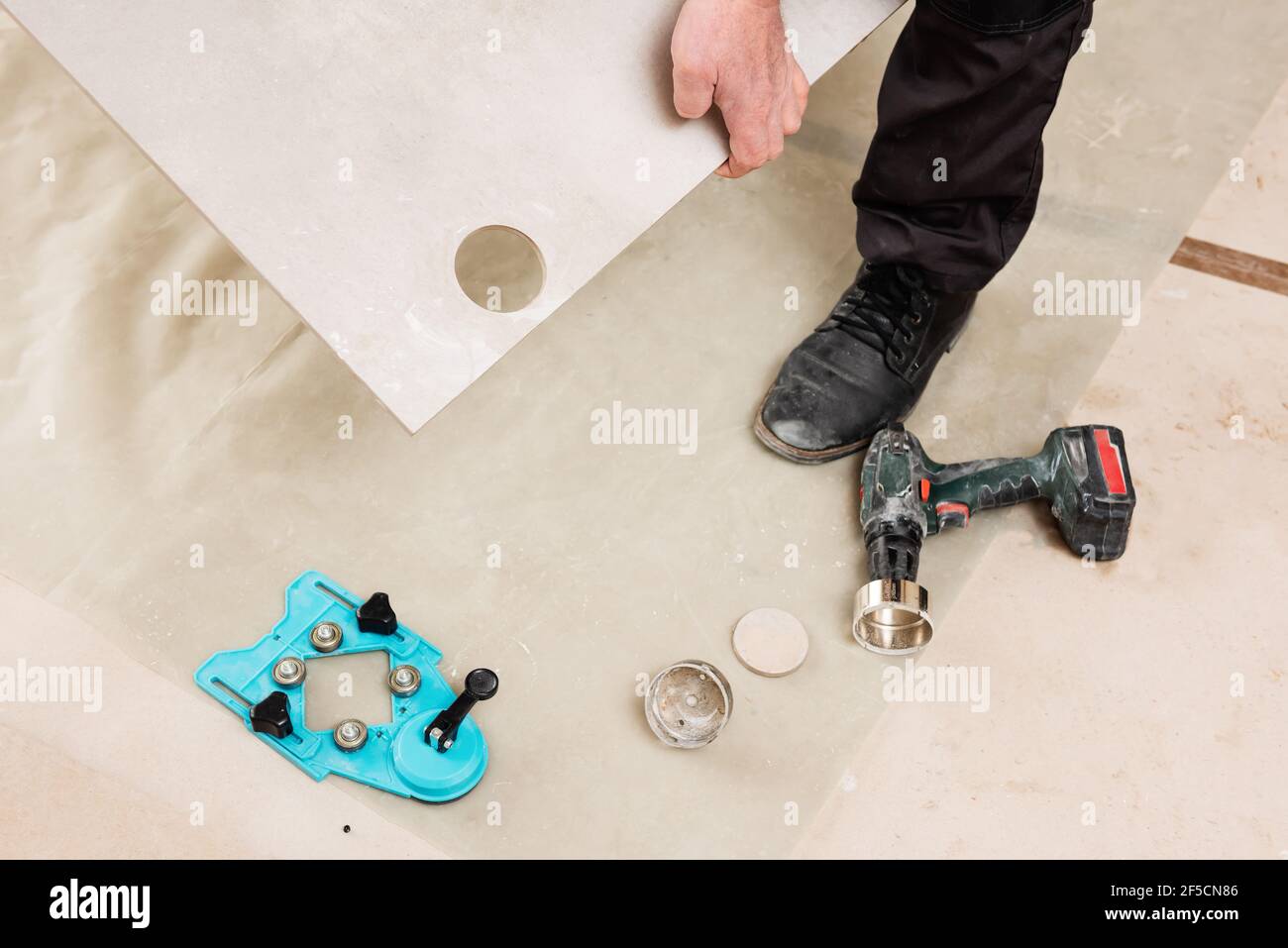 Worker holding tile adhesive hi-res stock photography and images - Alamy