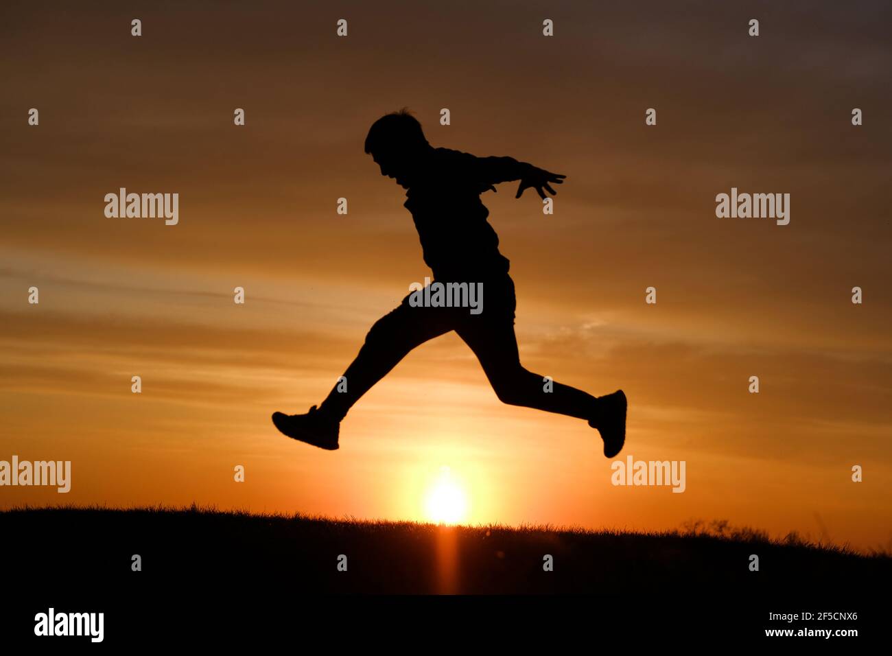 Female silhouette jump at sunset background Stock Photo - Alamy
