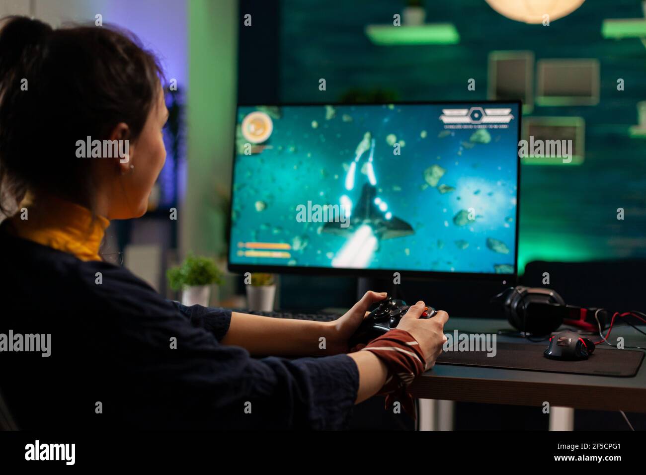 Caucasian woman holding wireless joystick and playing virtual ...