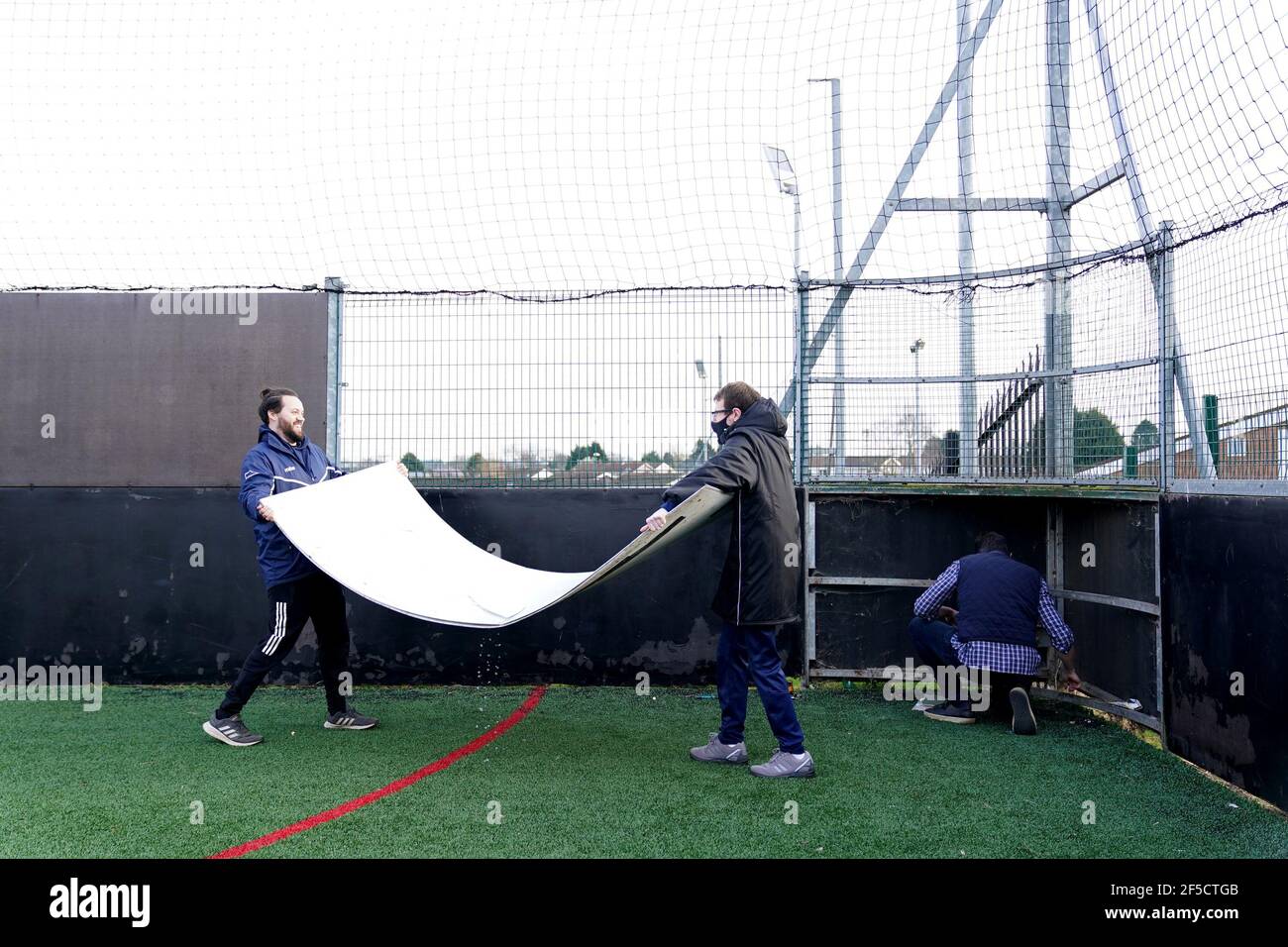 Members of staff fix sections of the pitch at Astro Kings 5-a-side ...