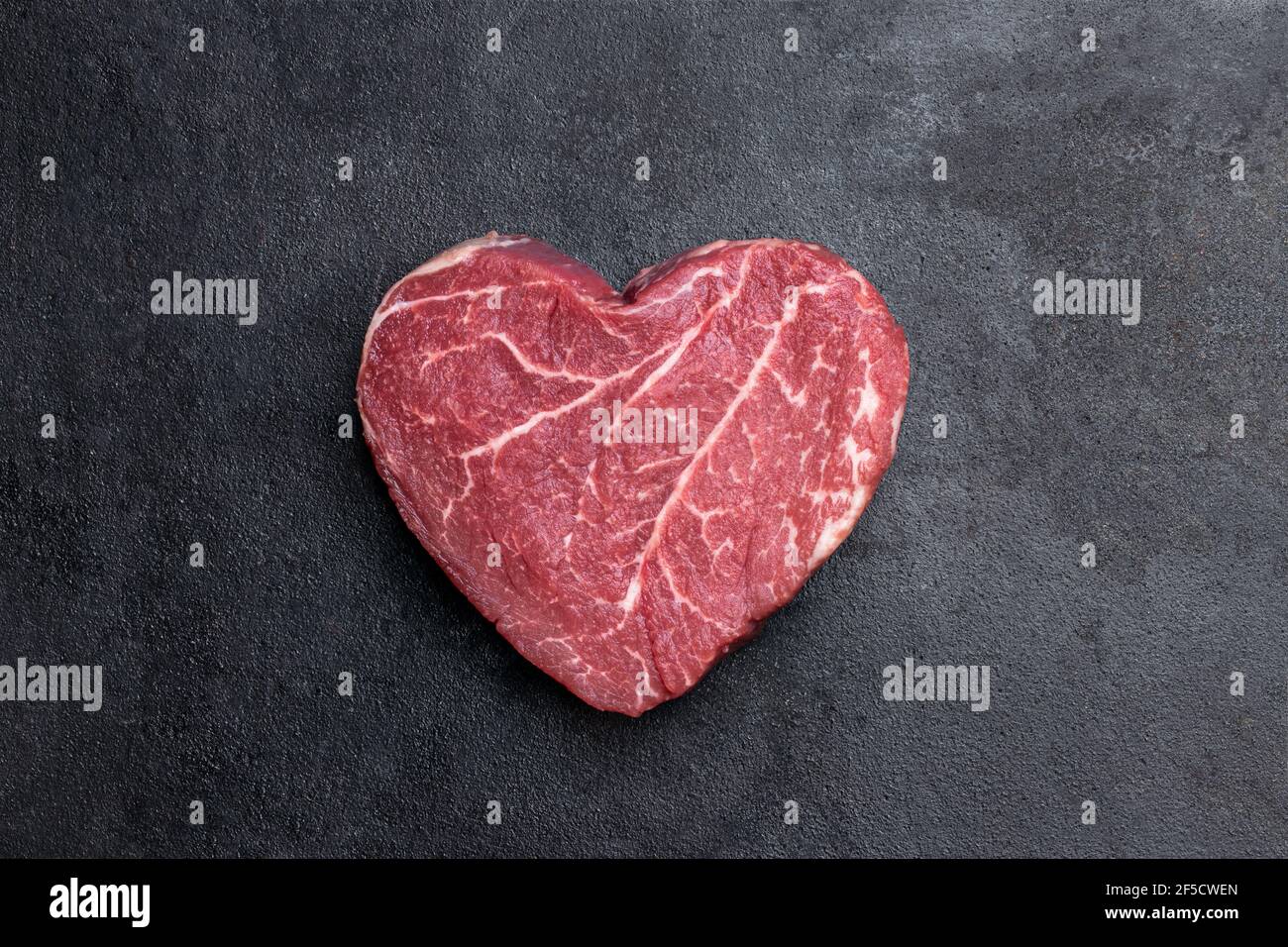 Heart shape raw fresh beef steak on metal background Stock Photo - Alamy