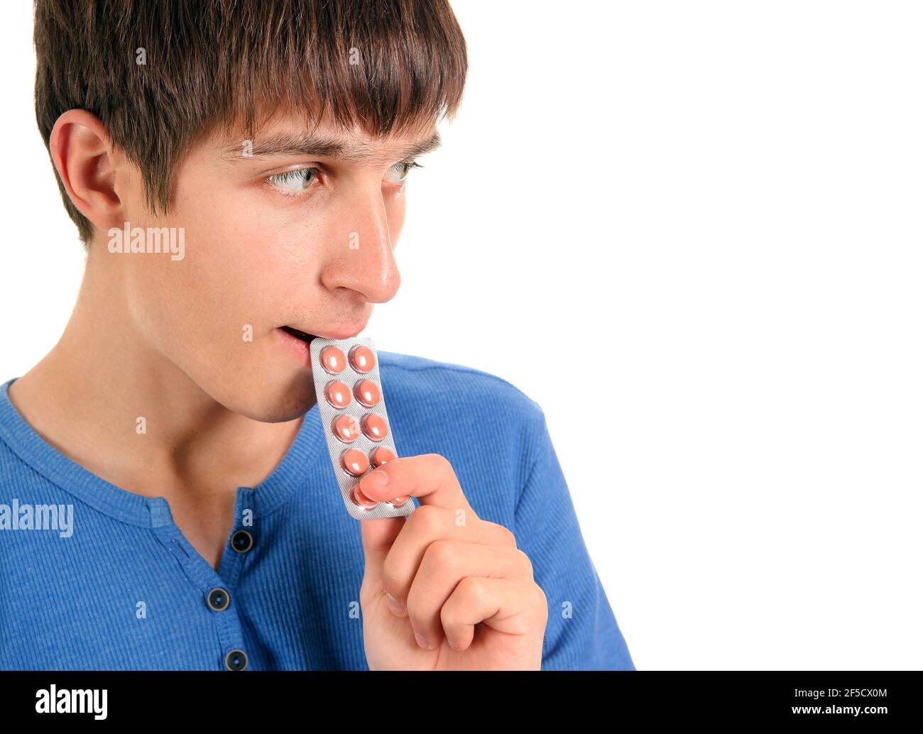 Pensive Young Man with a Pills on the White Background closeup Stock ...