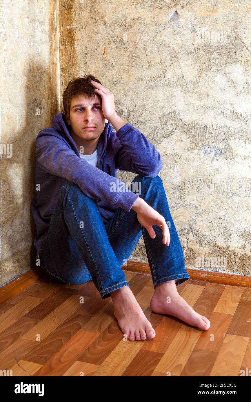 Sad Young Man in the Corner on the Floor by the Old Wall Stock Photo ...