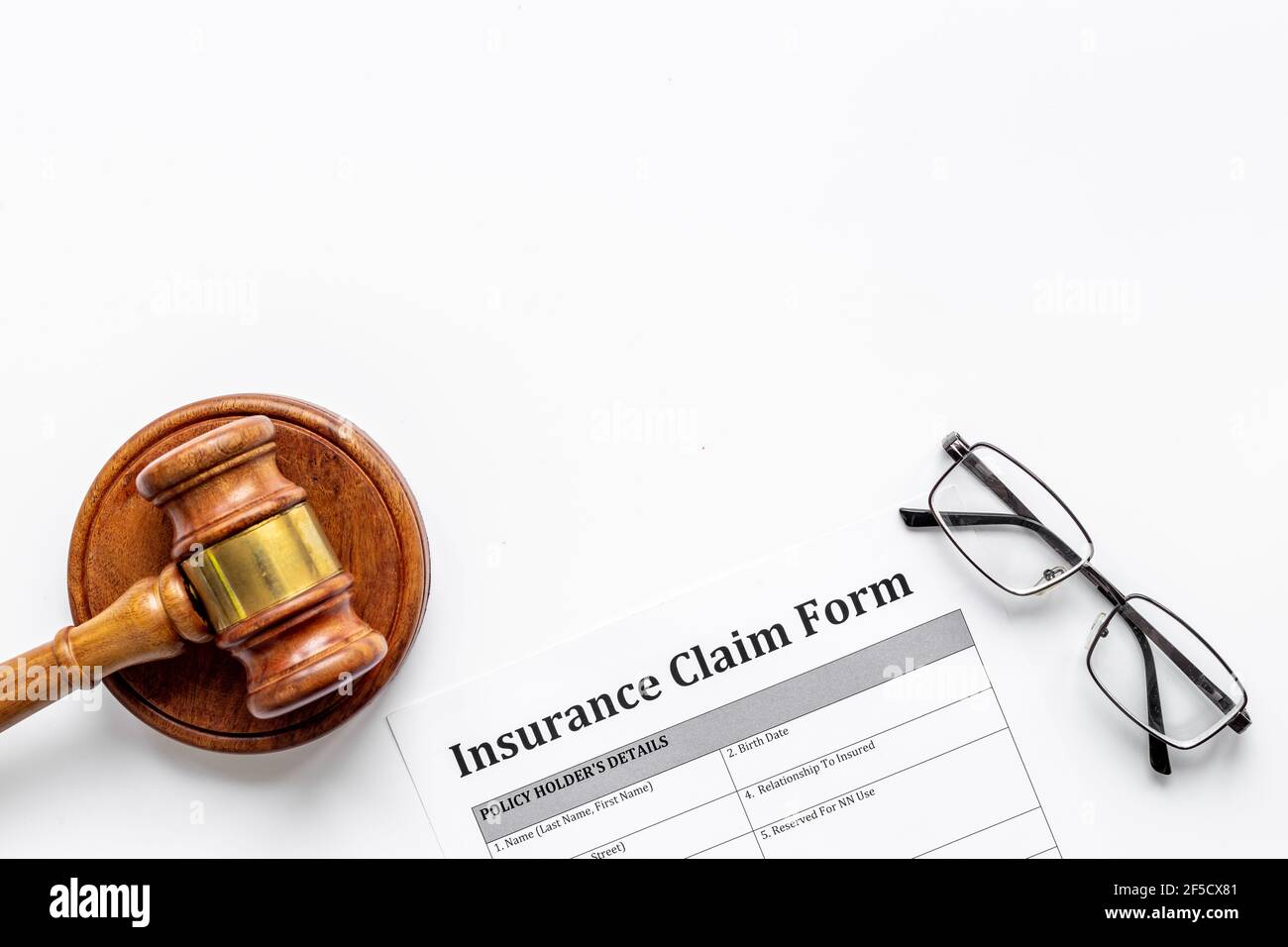 Insurance claim form with judge gavel . Top view Stock Photo - Alamy