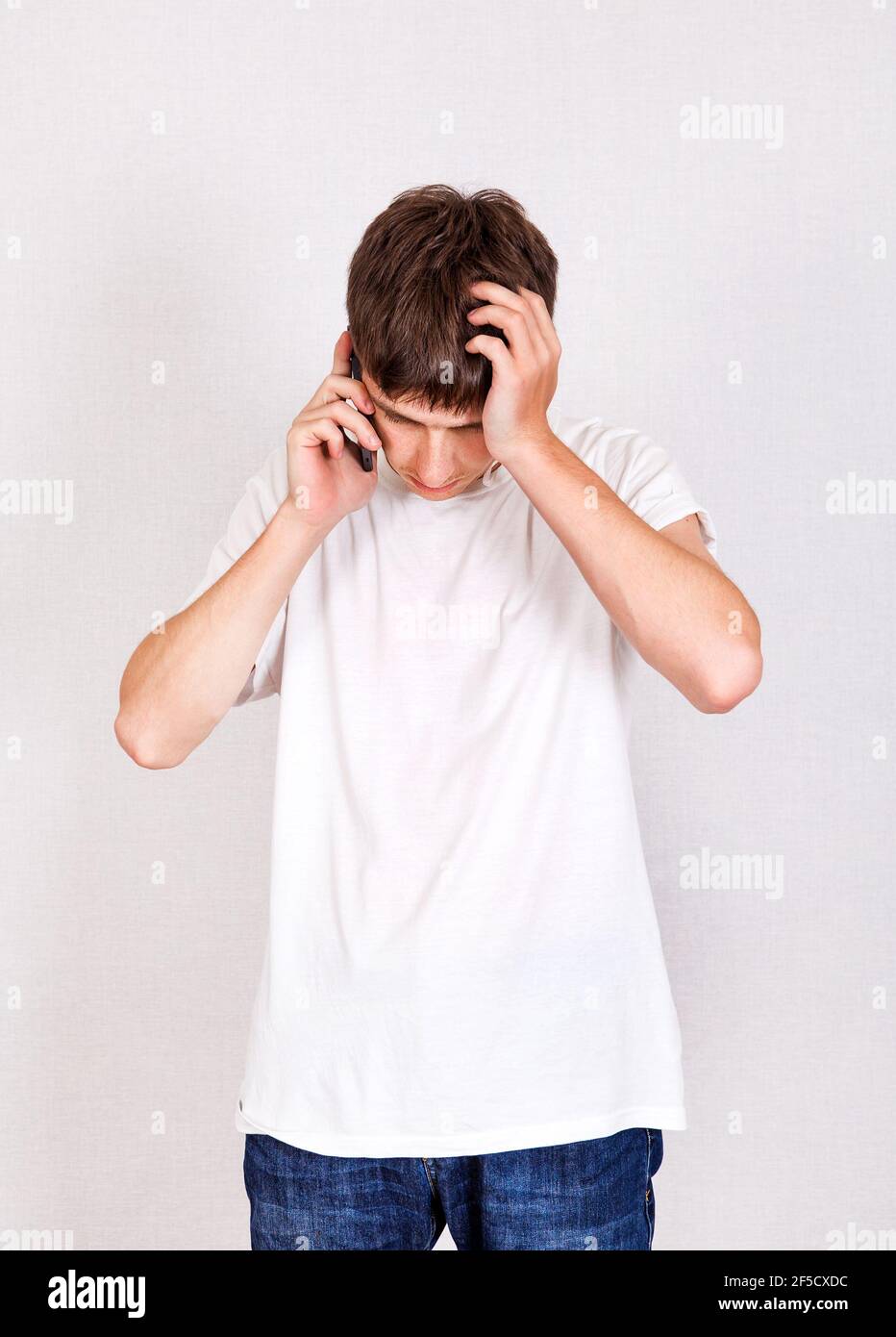 Sad Young Man speak on the Phone Isolated on the White Background Stock ...