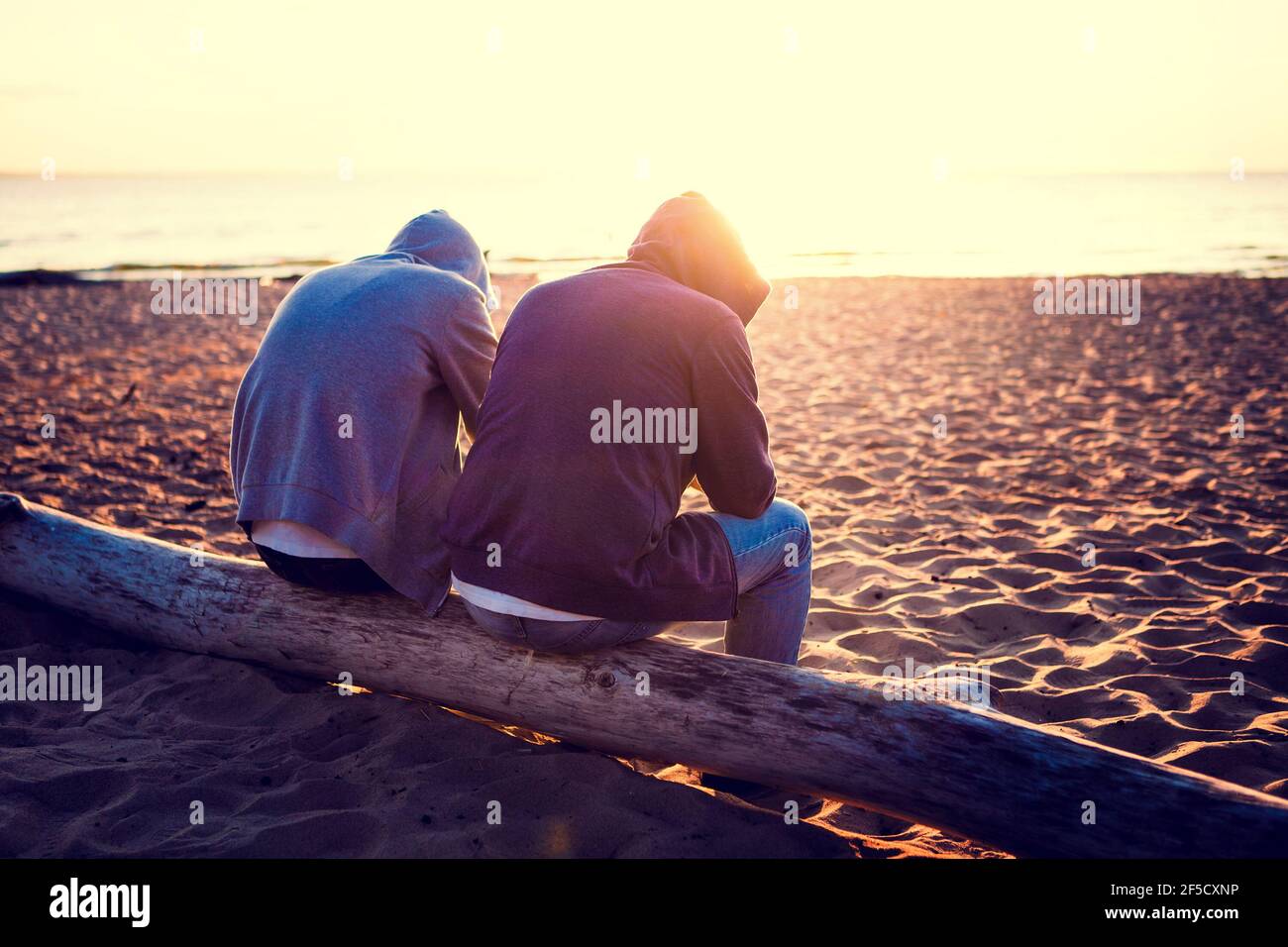 Toned Photo of Two Men on the shore at Sunset Stock Photo - Alamy