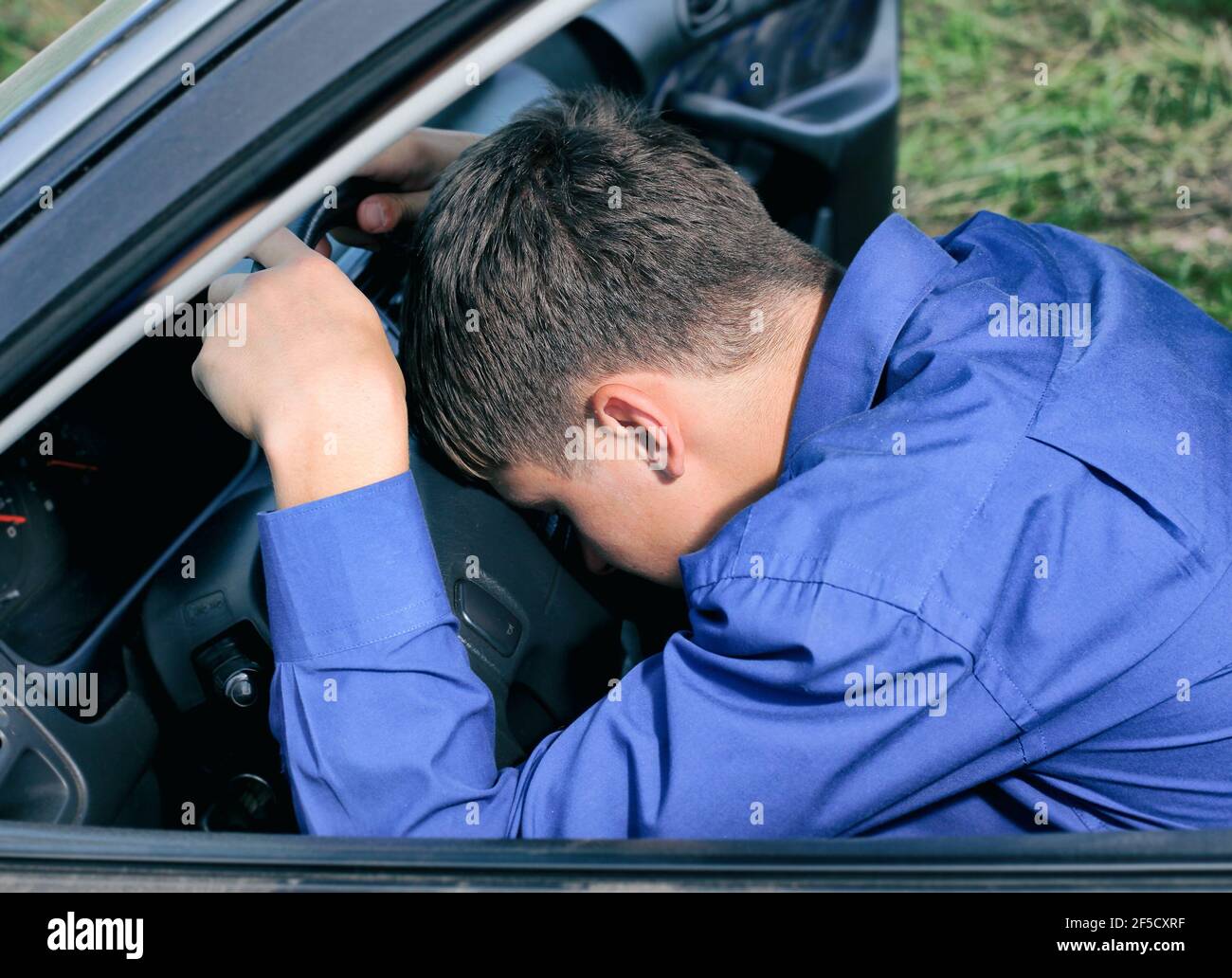 Tired Young Man sleep in a Car Stock Photo - Alamy