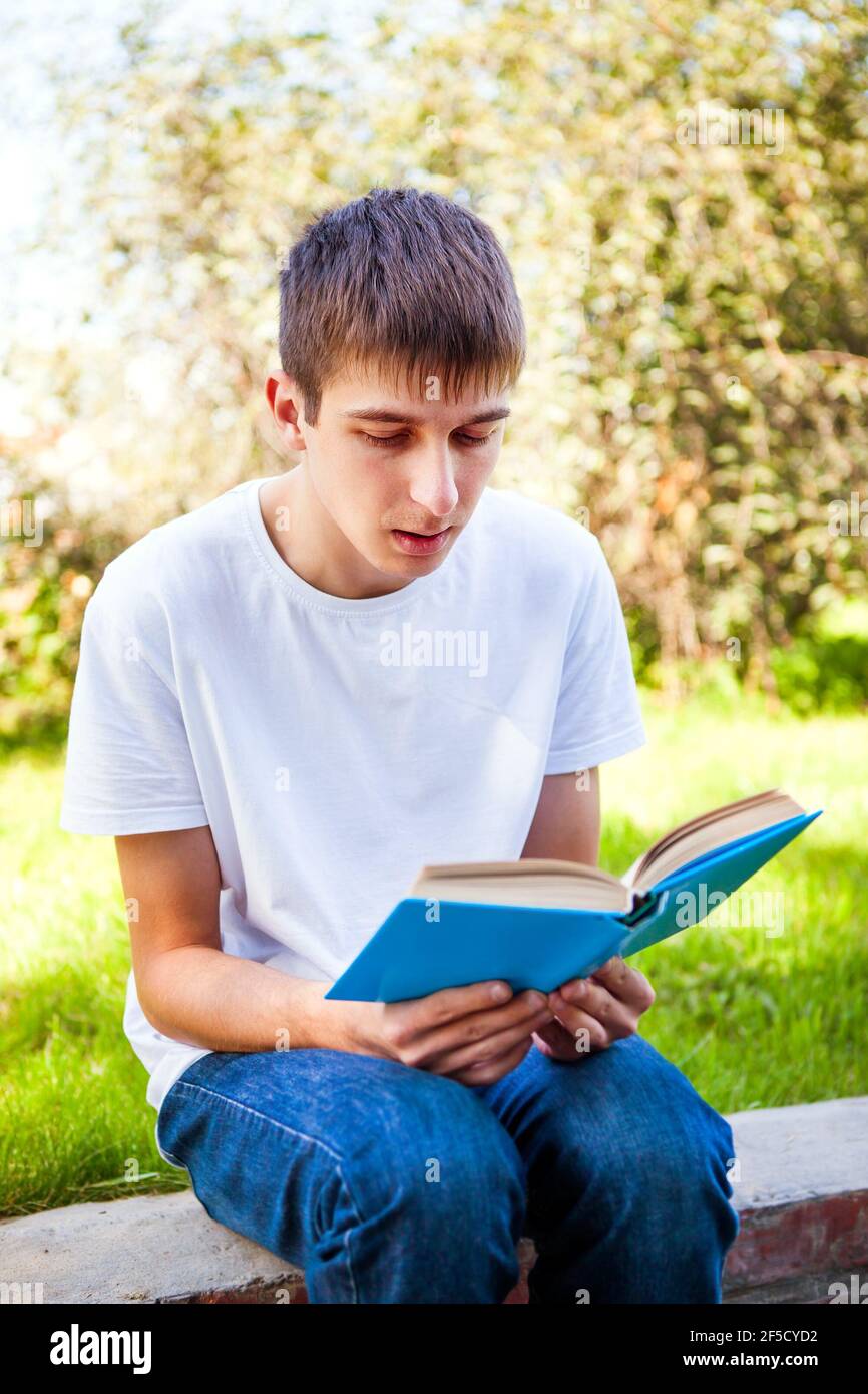 Young man opened book reading hi-res stock photography and images - Alamy