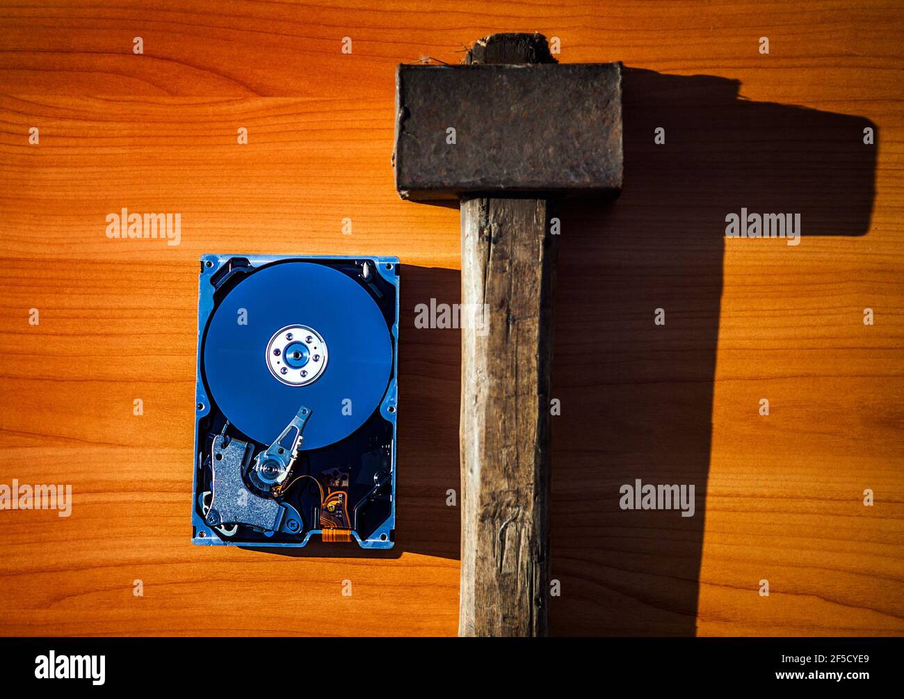 Opened Hard Disk Drive on the Table with the Old Hammer Stock Photo - Alamy
