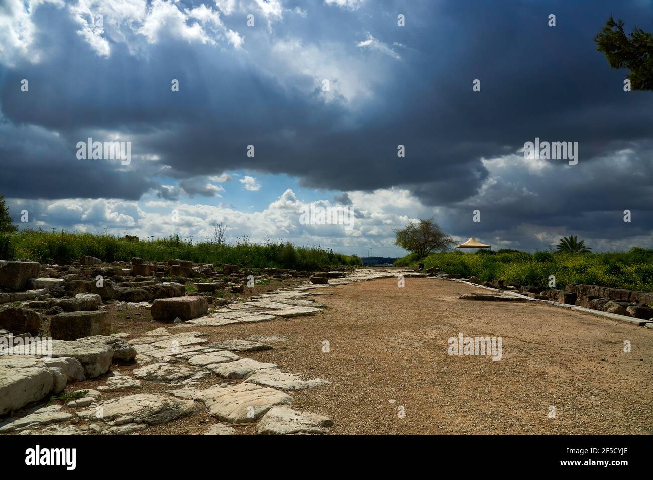 Ancient Rome road remains and cloudy sky after the rain Stock Photo - Alamy