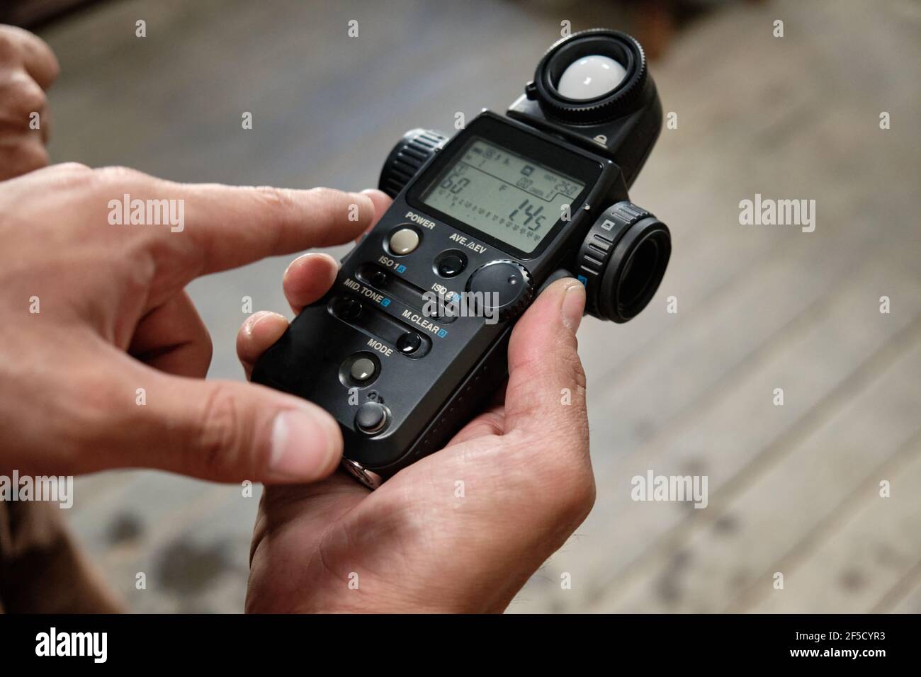 Testing the light exposure with a light meter in a cinema shot Stock ...