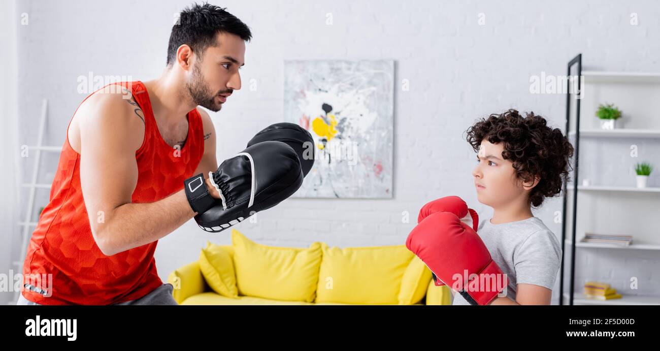 Boy boxing training punch mitts hi-res stock photography and images - Alamy