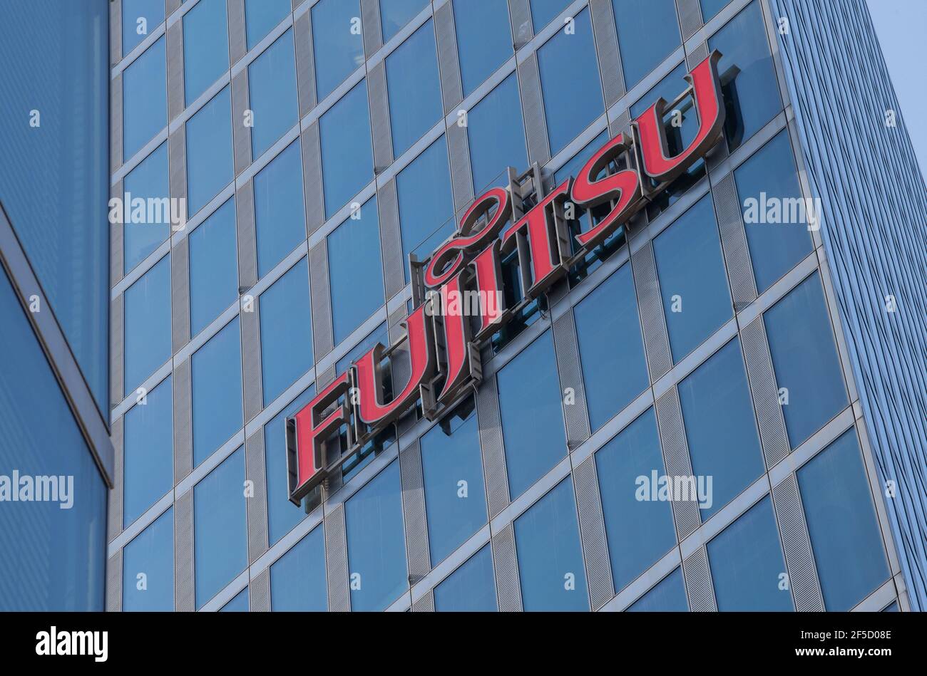 Munich, Germany. 26th Mar, 2021. The Fujitsu logo hangs on the facade ...