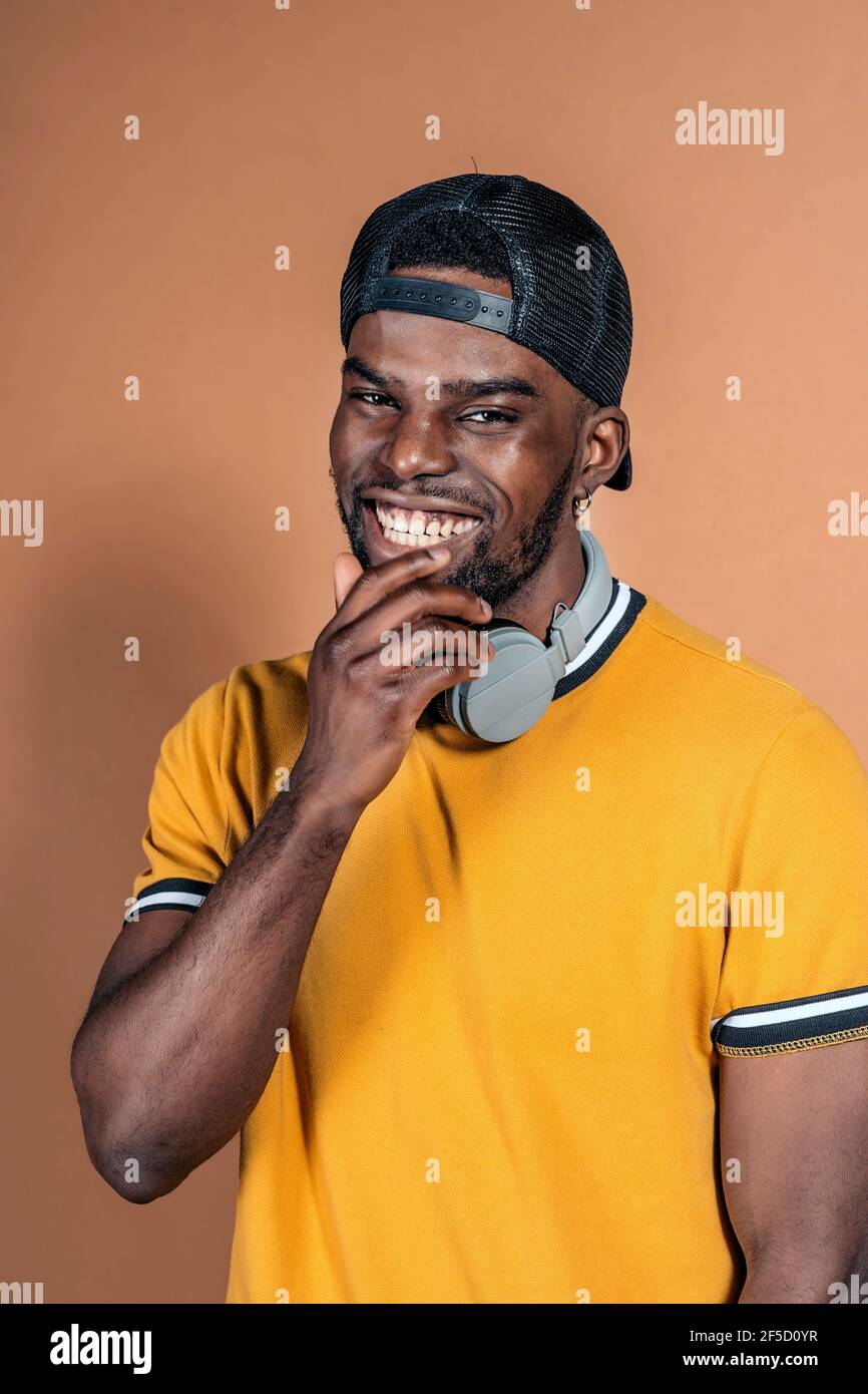 Stock photo of handsome black man wearing headphones looking at camera ...