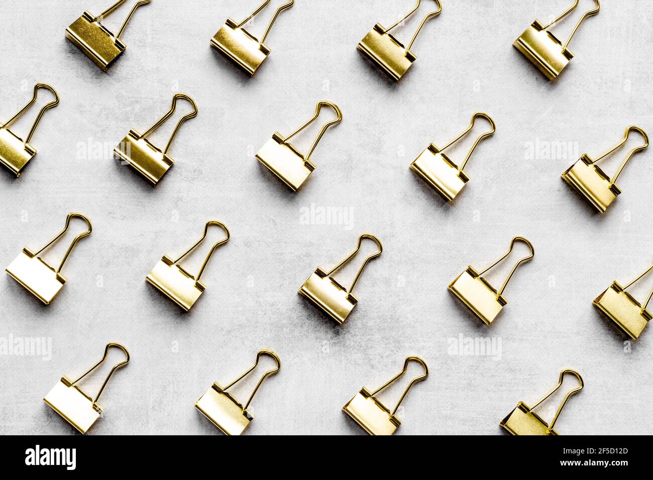 Stationery pattern. Paper binder clips top view Stock Photo - Alamy