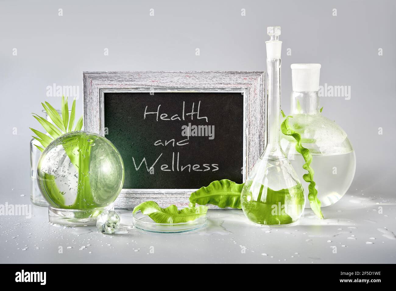 Natural Green laboratory. Text Health and Wellness on blackboard, chalk ...