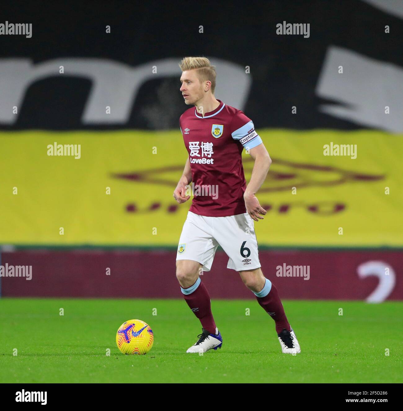 Ben Mee #6 of Burnley runs with the ball Stock Photo - Alamy