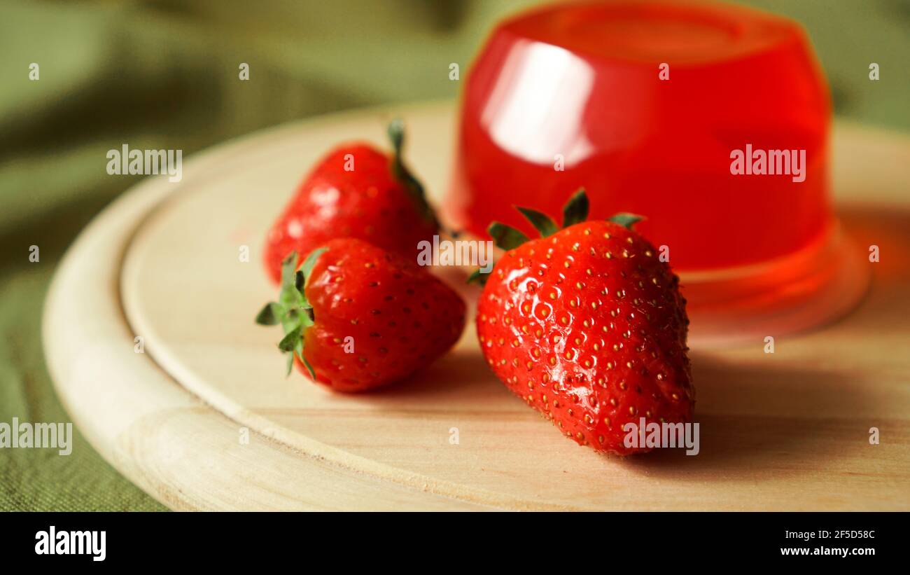 Red strawberry jelly with berries in a plastic container Stock Photo ...