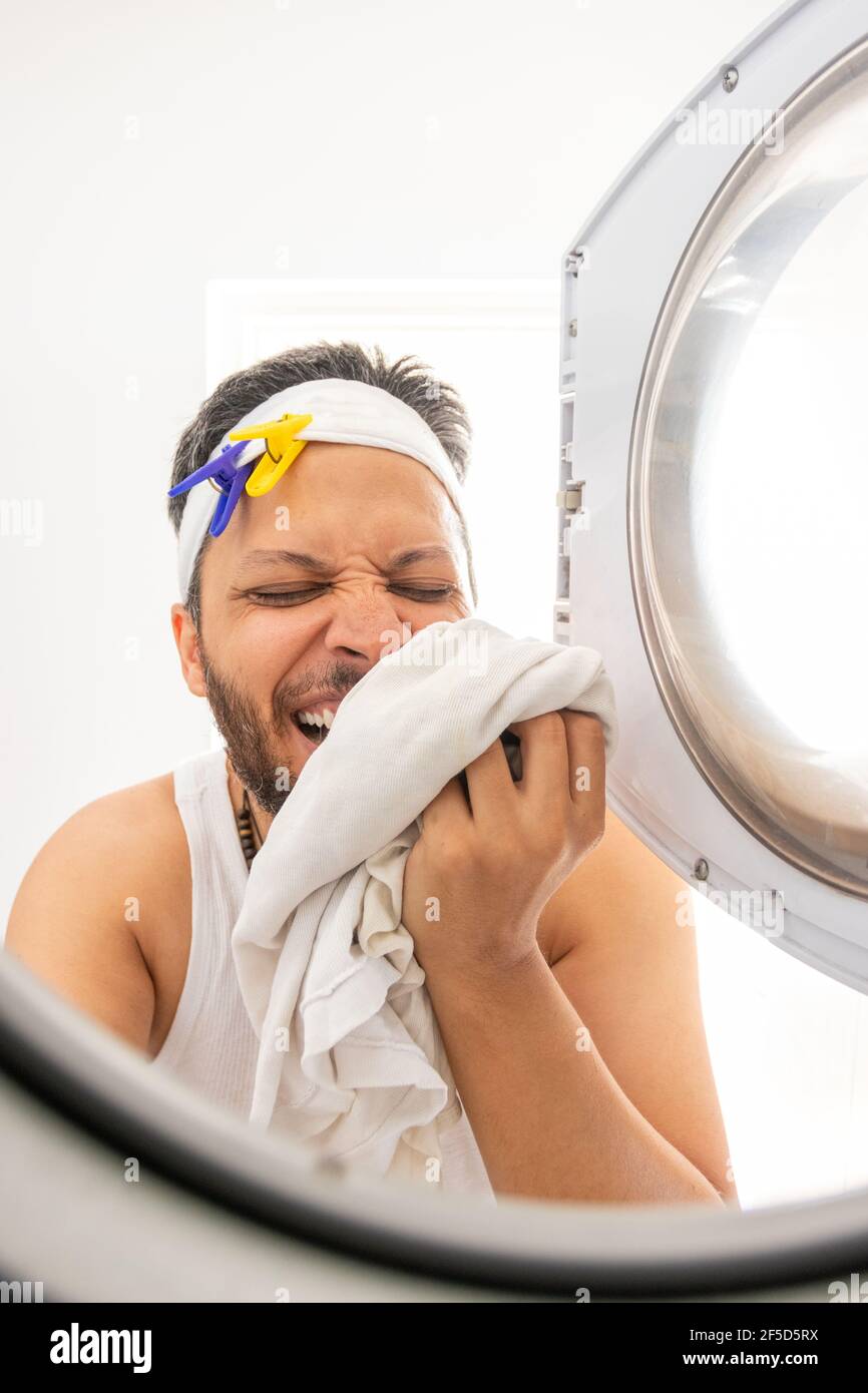 Portrait of young man waiting in laundry hi-res stock photography and ...