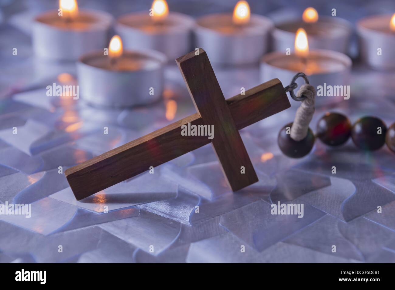 Wooden cross with candles in the background Stock Photo - Alamy