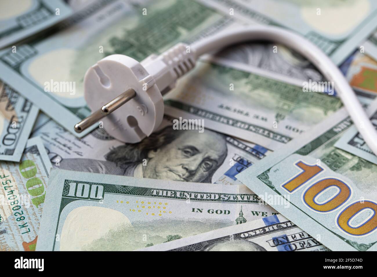 white plug on dollar banknotes background Stock Photo - Alamy