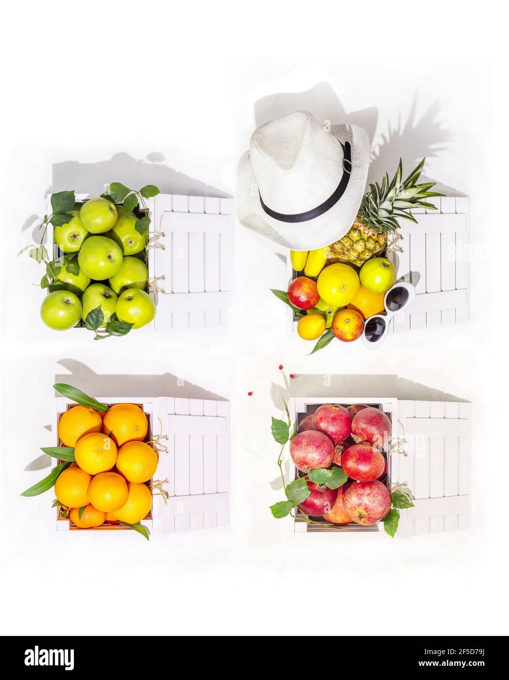 Vertical composition with ripe, seasonal, organic fruit in white boxes ...