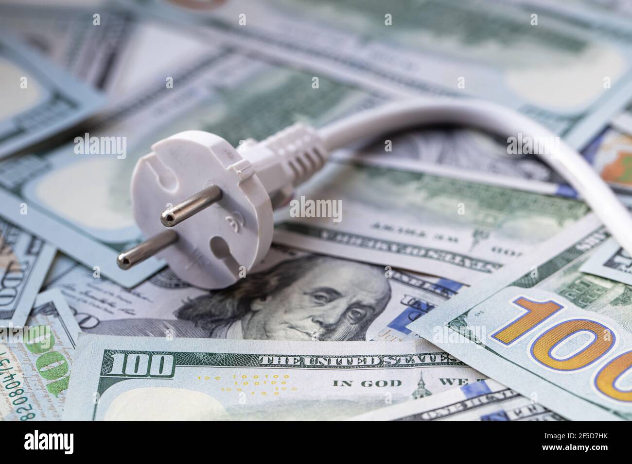 white plug on dollar banknotes background Stock Photo - Alamy