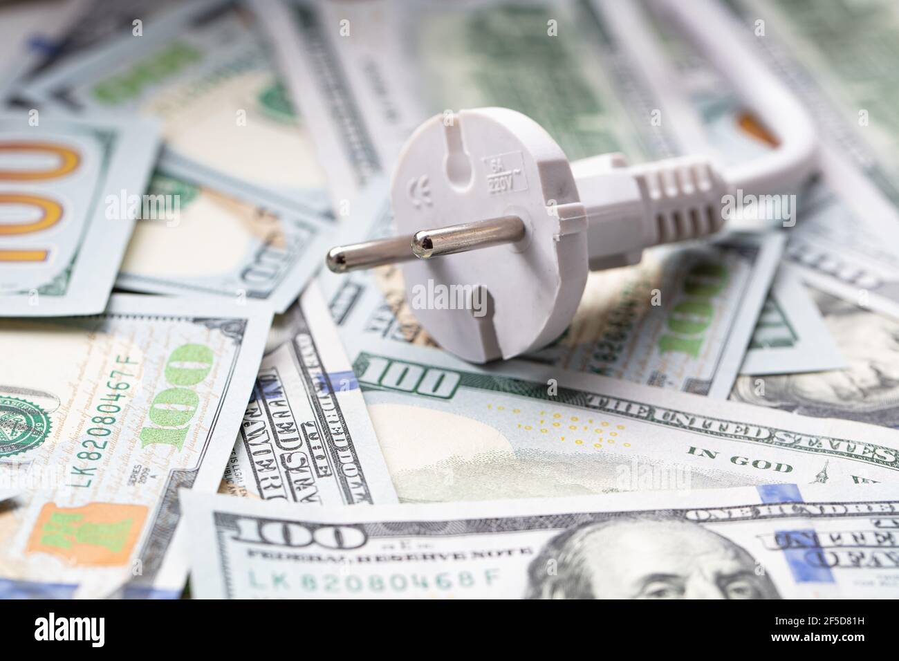 white plug on dollar banknotes background Stock Photo - Alamy