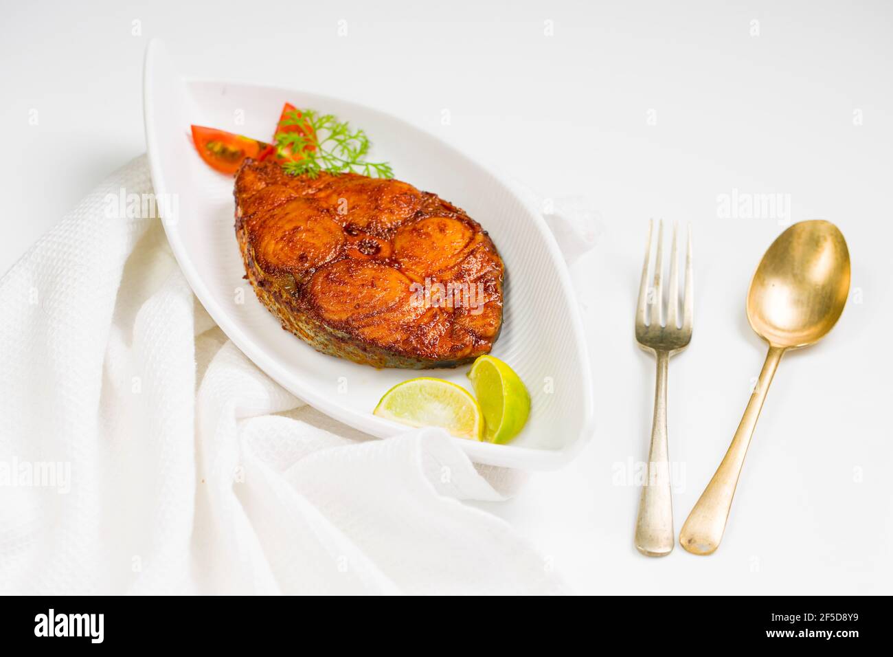 Seer fish fry arranged beautifully and garnished with onion, lemon and ...