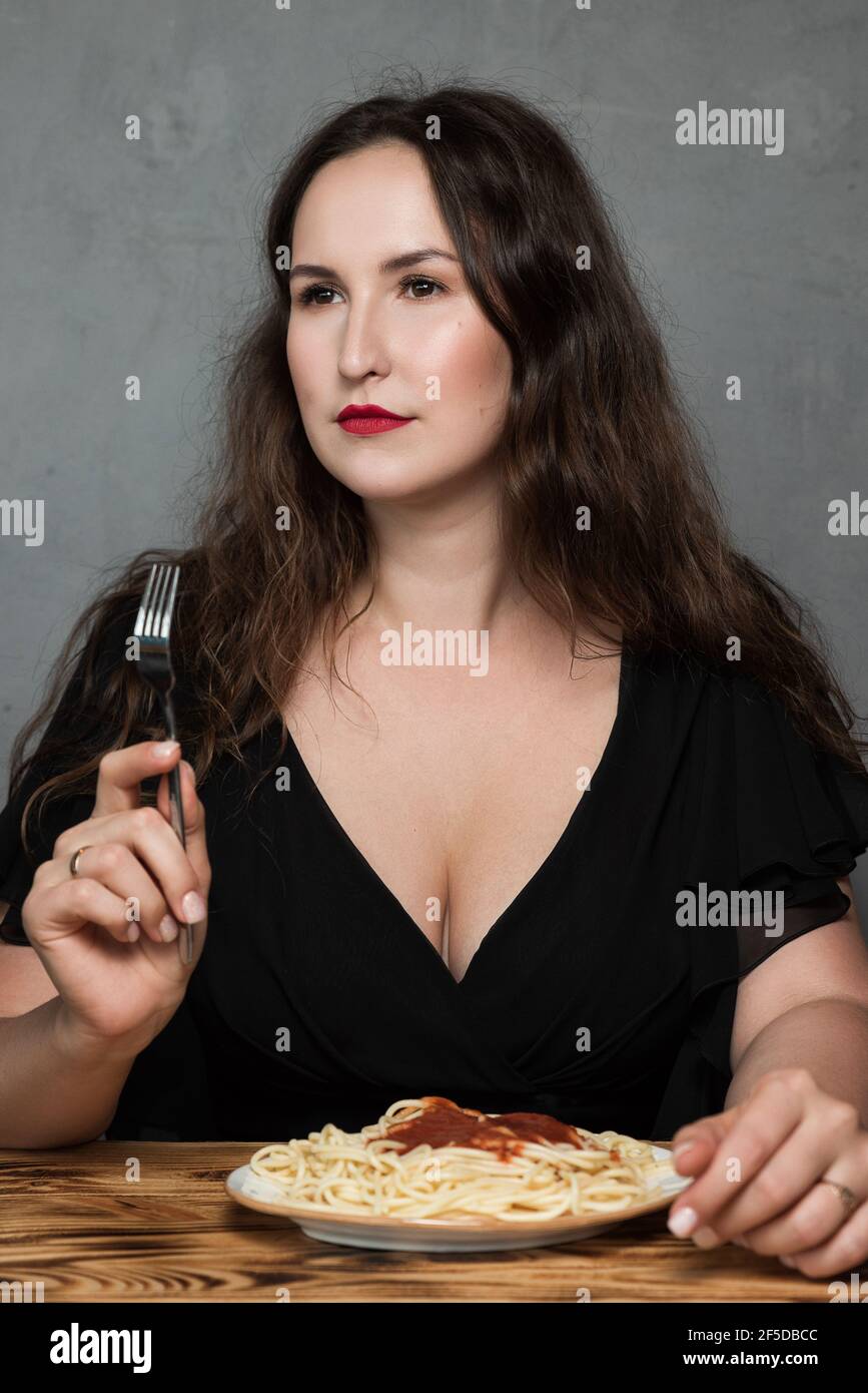 A Beautiful Young Woman Eats Italian Spaghetti Pasta The Brunette Girl